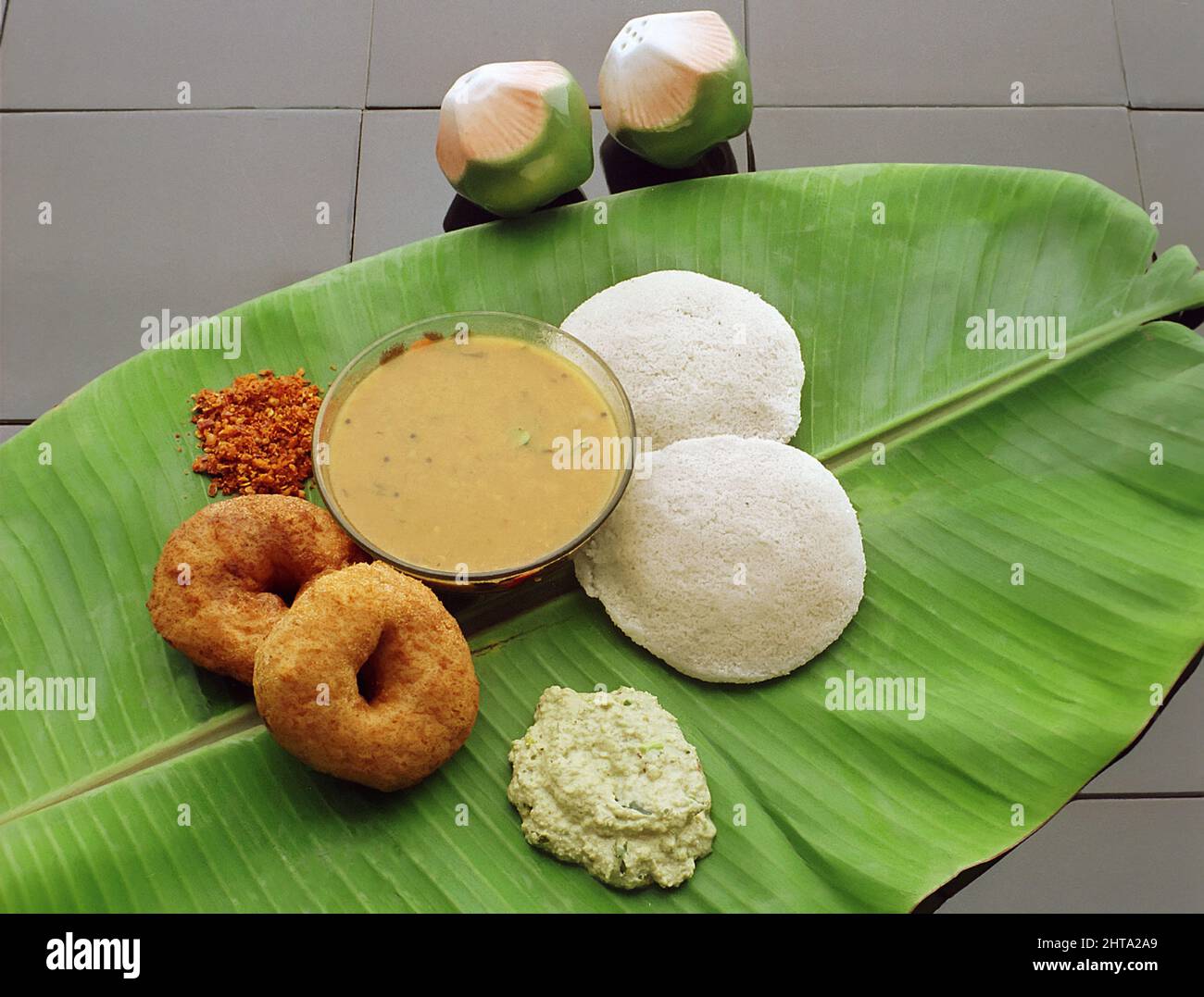 Closeup of Idli & wada with sambarchutney karam podi served on banana ...