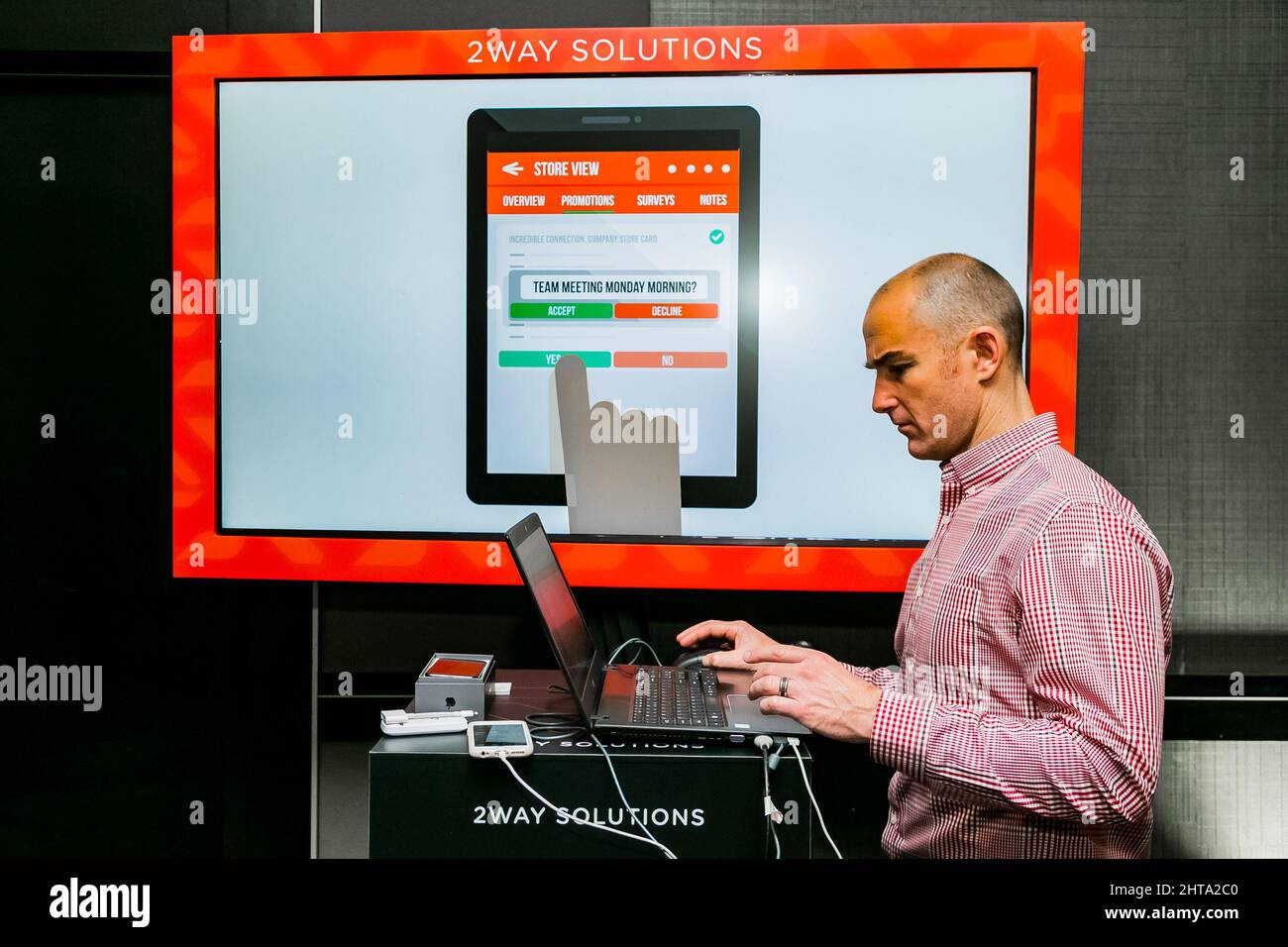 Vendors demonstrating a product service at retail industry conference ...