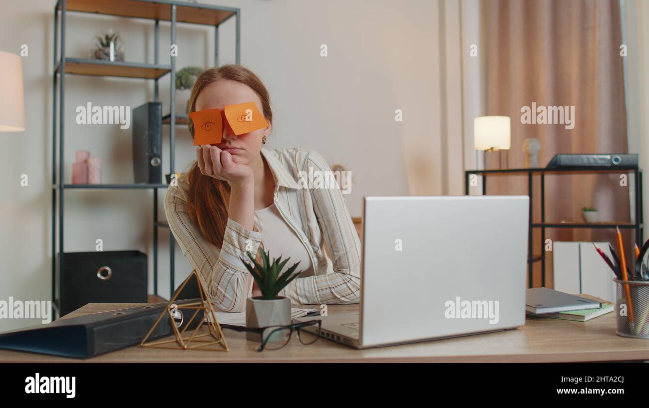 Tired woman freelancer using laptop computer napping at home office ...