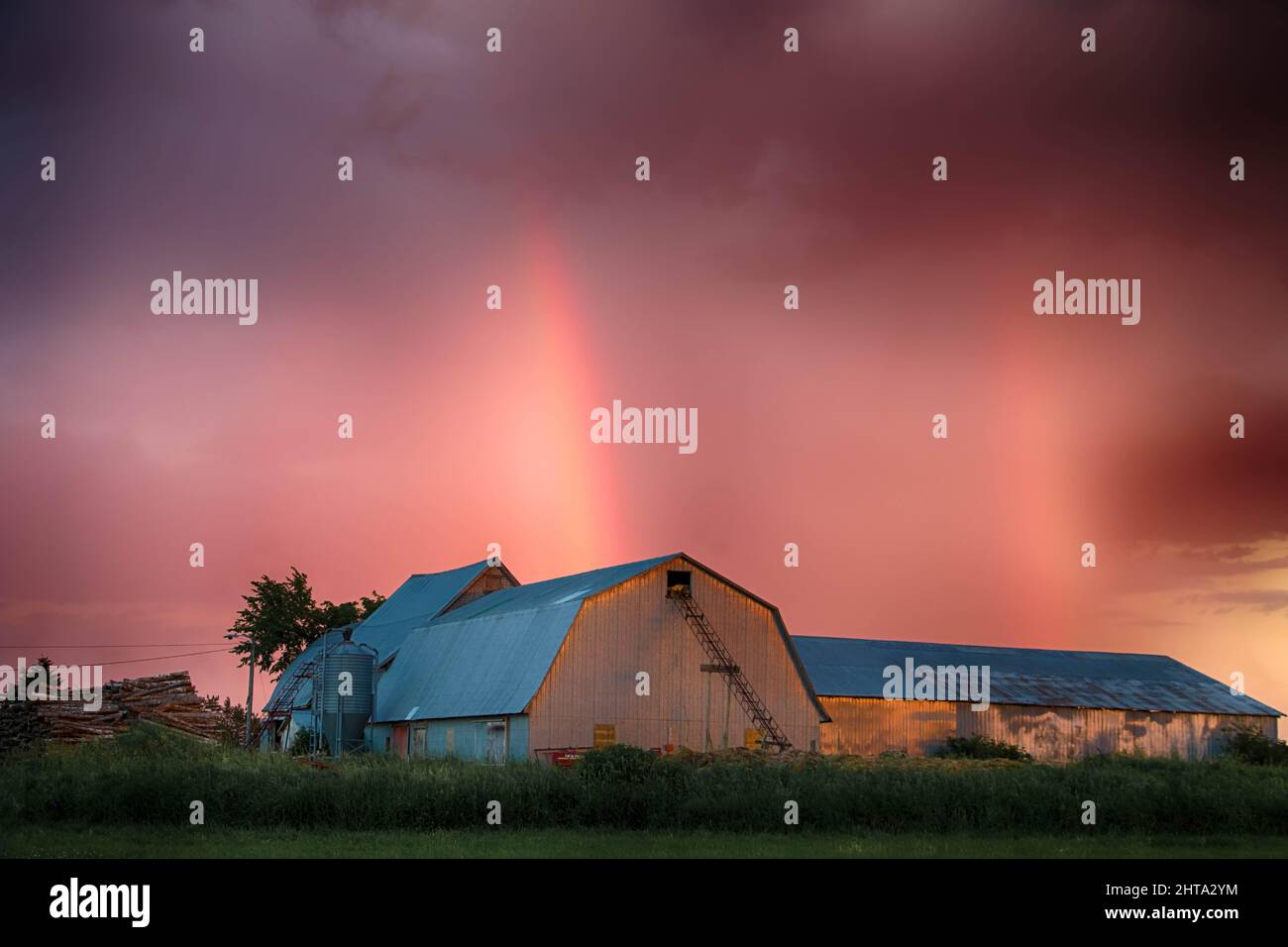 Landscape of a barn in a field with rainbow above it Stock Photo - Alamy