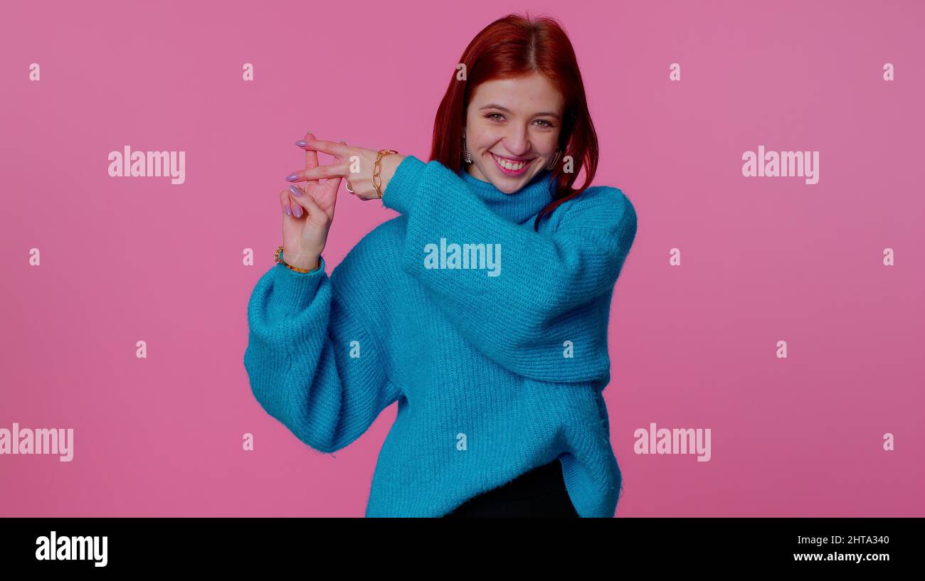 Cheerful teen girl showing hashtag symbol with hands, likes tagged ...