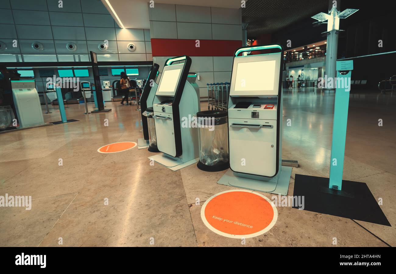 A side view of self-serve flight check-in electronic machines in a ...