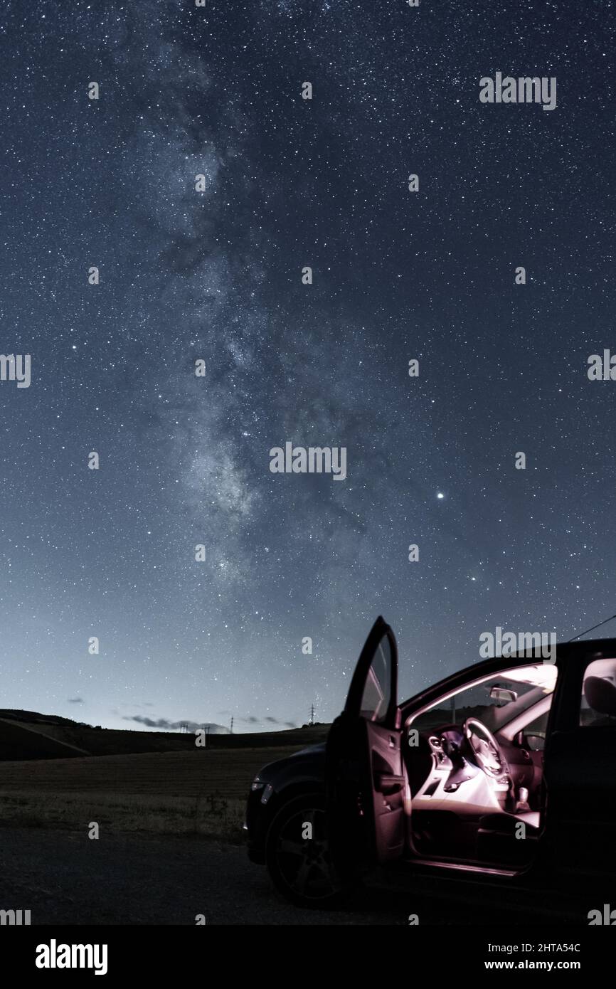 Vertical shot of a starry night in the countryside next to a car Stock ...