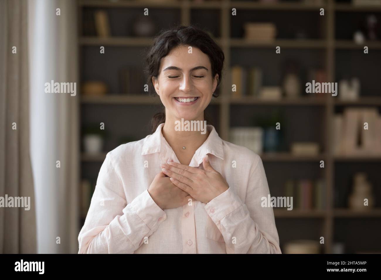 Hands folded to chest hi-res stock photography and images - Alamy