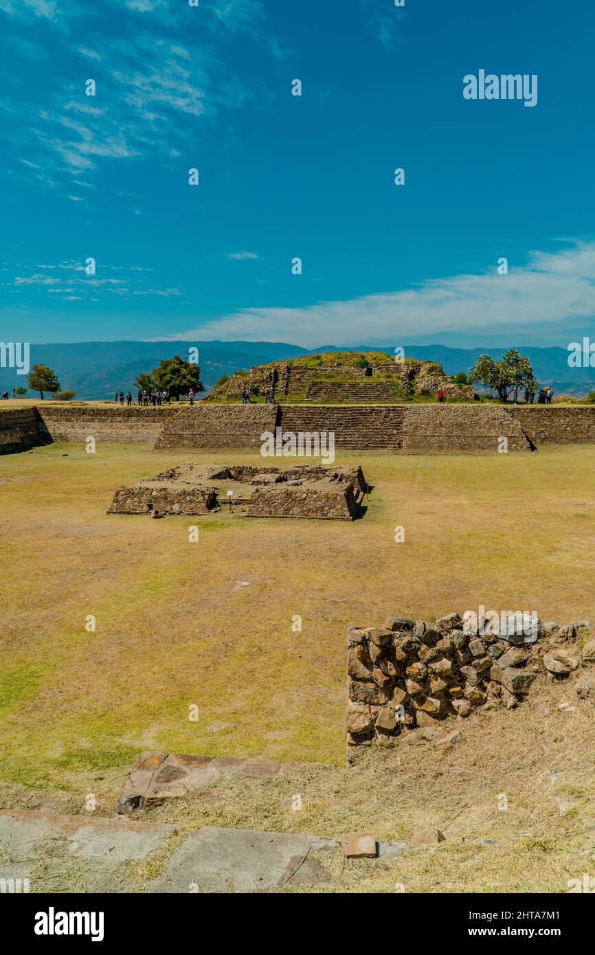 Vertical shot of tourists visiting Zapotec temples inside the ...