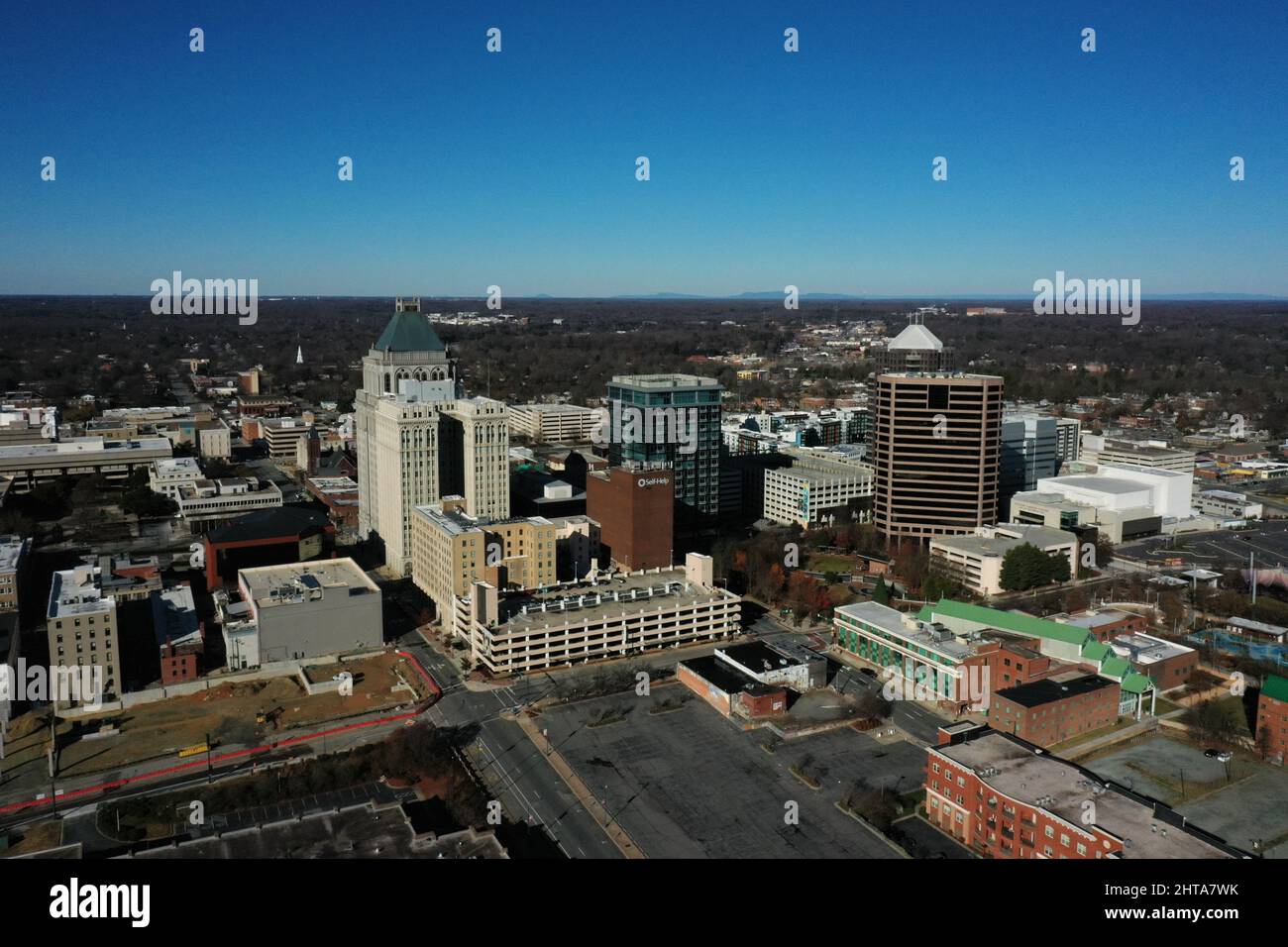 Aerial view of the skyline of Greensboro, NC with Pilot Mountain ...