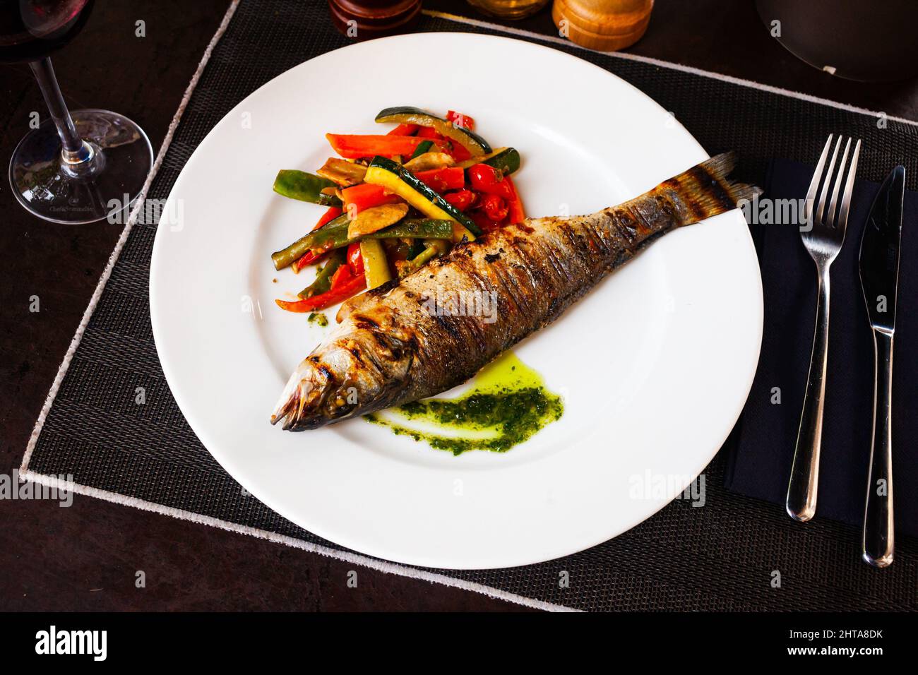 Delicious fish dish - baked sea bass with stewed vegetables Stock Photo ...