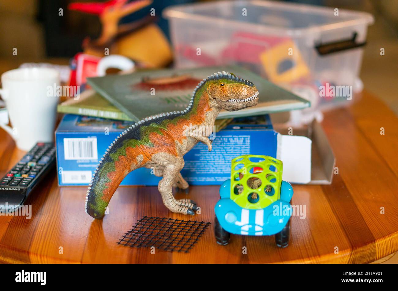 Schleich brand Giganotosaurus toy model dinosaur on a messy table Stock ...