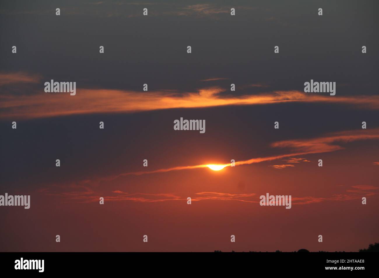 Beautiful sunset background with the sun behind the clouds Stock Photo ...