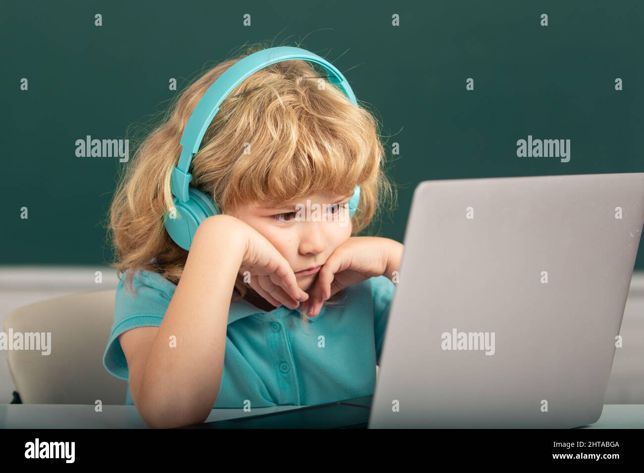 Serious boy student learning online in class. Kid study online video ...