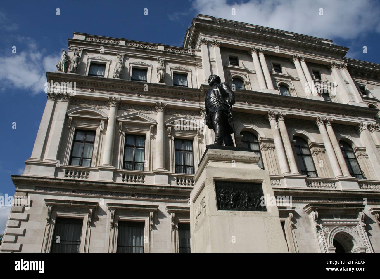 Closeup of an old stone building with arched windows and sculptures in ...