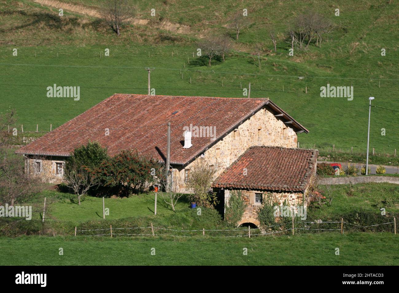 Scenic view of a typical Basque house of stone in the middle of a green ...