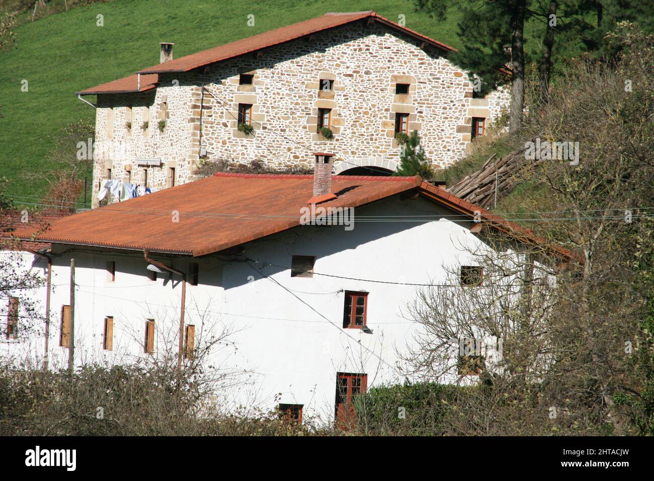 Scenic view of a typical Basque house of stone in the middle of a green ...