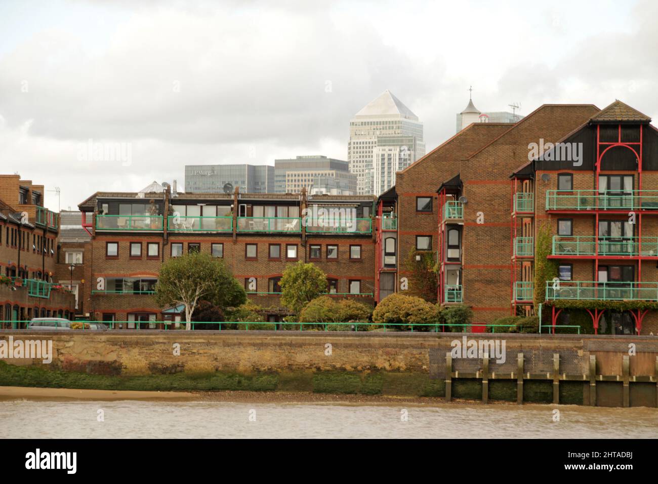 Brown buildings on the edge of a river with tall buildings in the ...