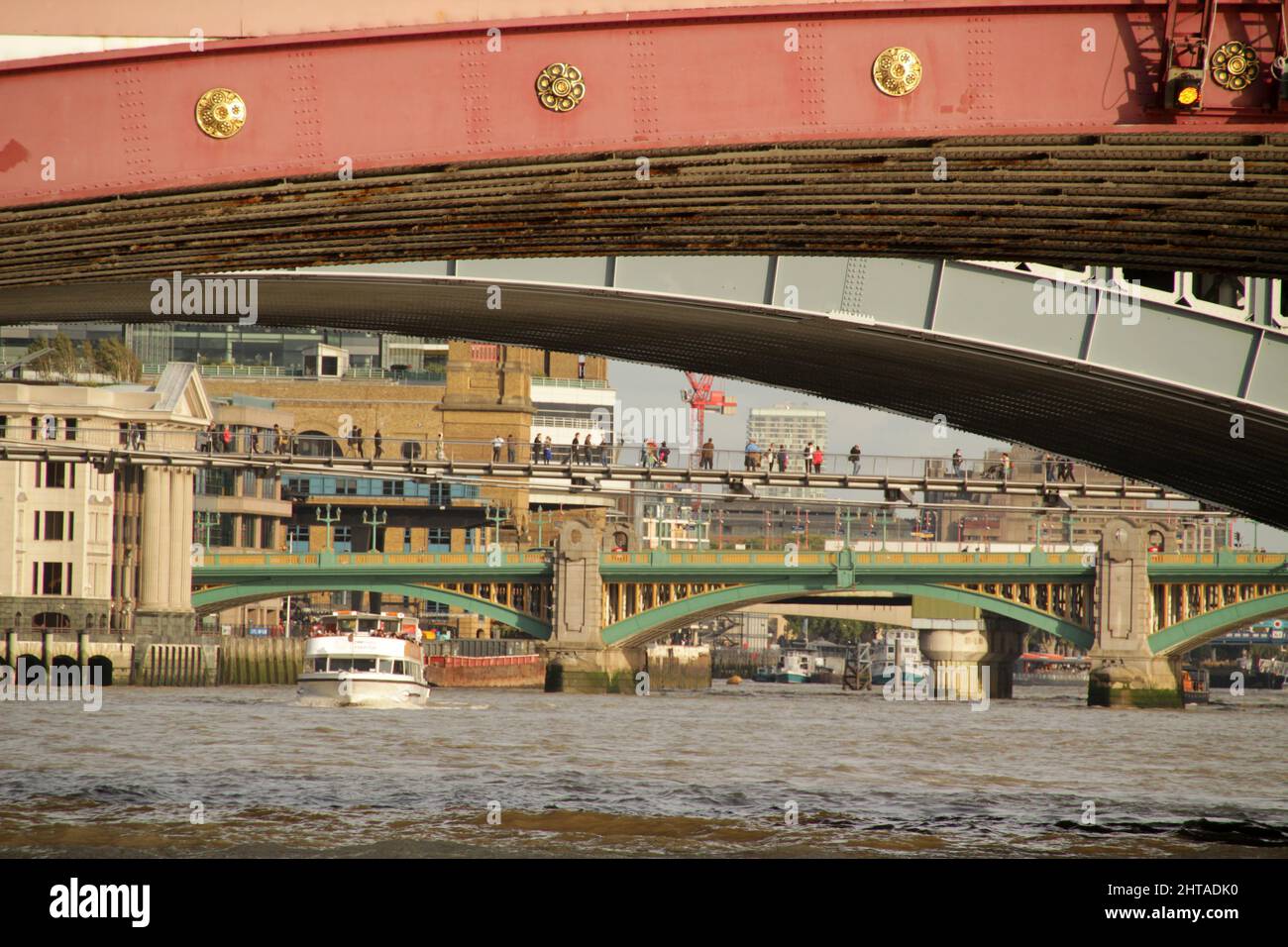 Bridges over a river with a boat surrounded by buildings in London, UK ...
