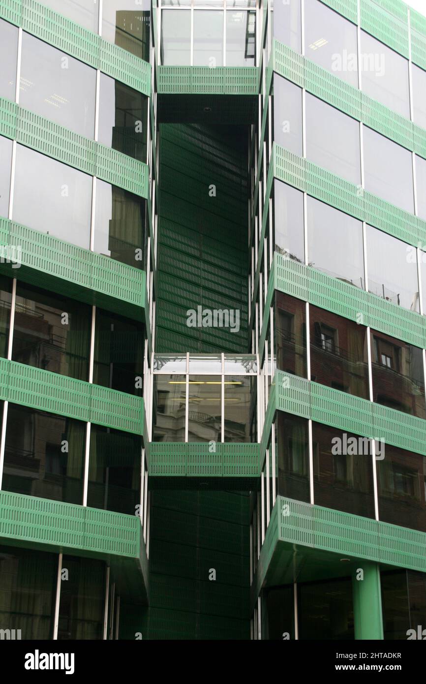 Vertical of glass windows and balconies of a modern green building in ...