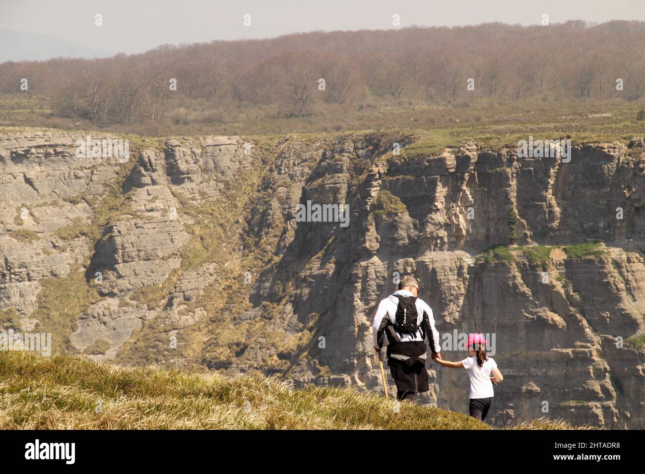 Male and a girl on the edge of a Canyon in Basque Country, Spain Stock ...