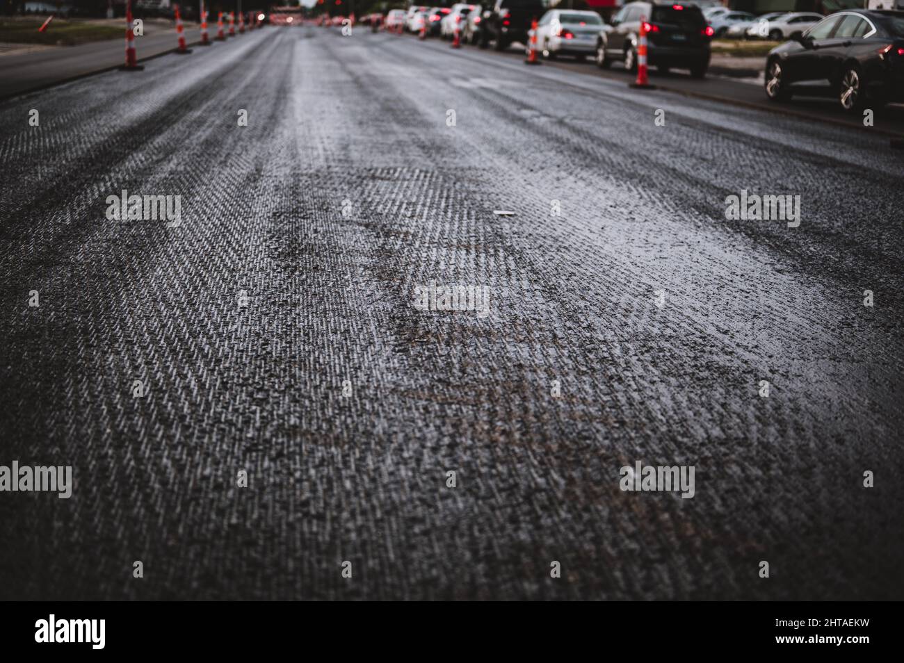 Low angle shot across a scarified street under construction with lanes ...