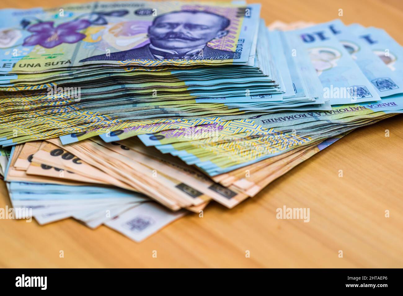 Closeup shot of 100 and 200 leu banknotes spread out on the black ...