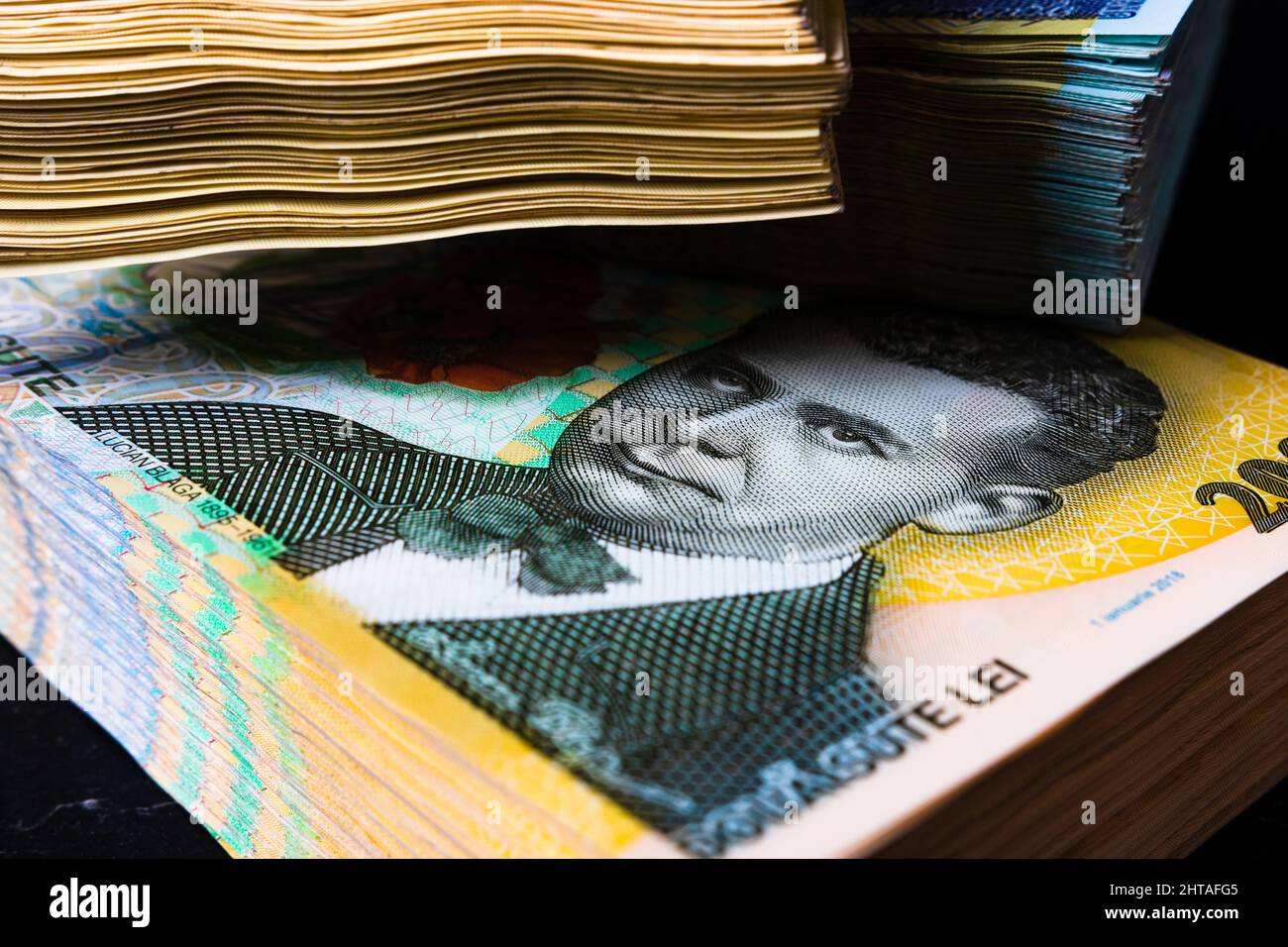 Closeup shot of 200 leu banknote stacks isolated on the black surface ...