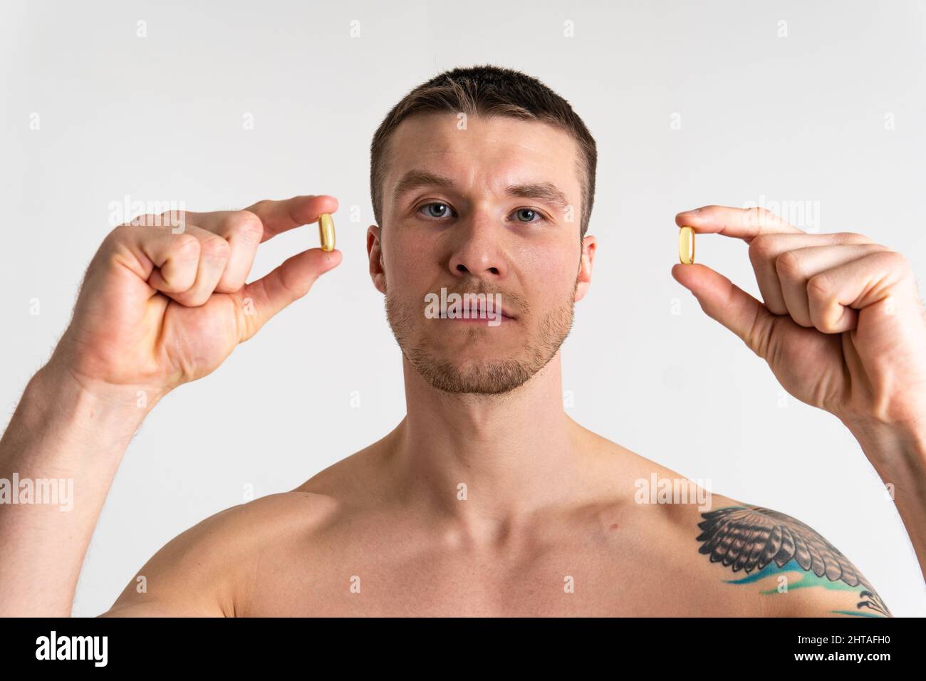 Fish oil is eaten by a man in the hands of vials and a glass bottle ...