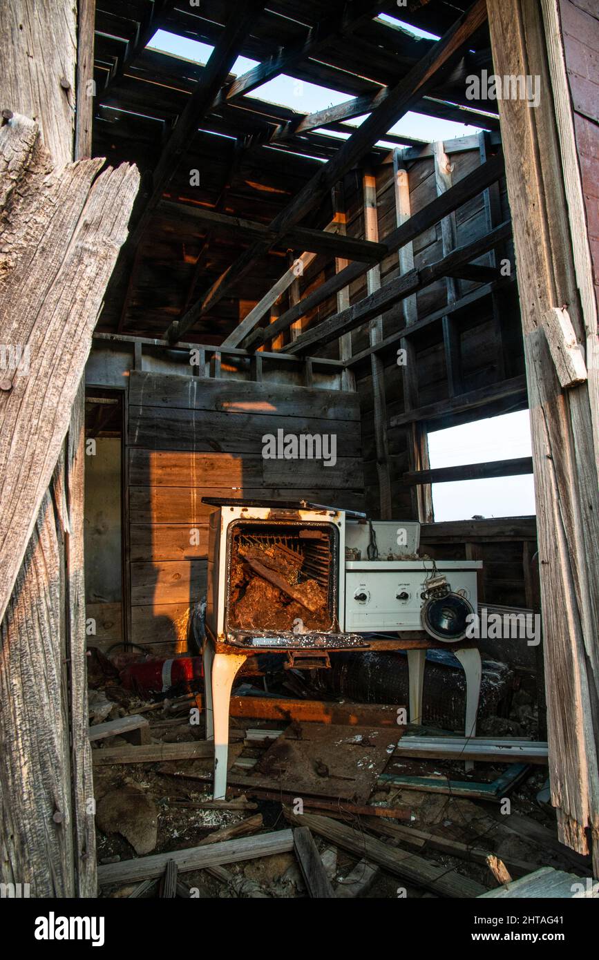 Old deserted wooden home full of discarded appliances and junk Stock ...