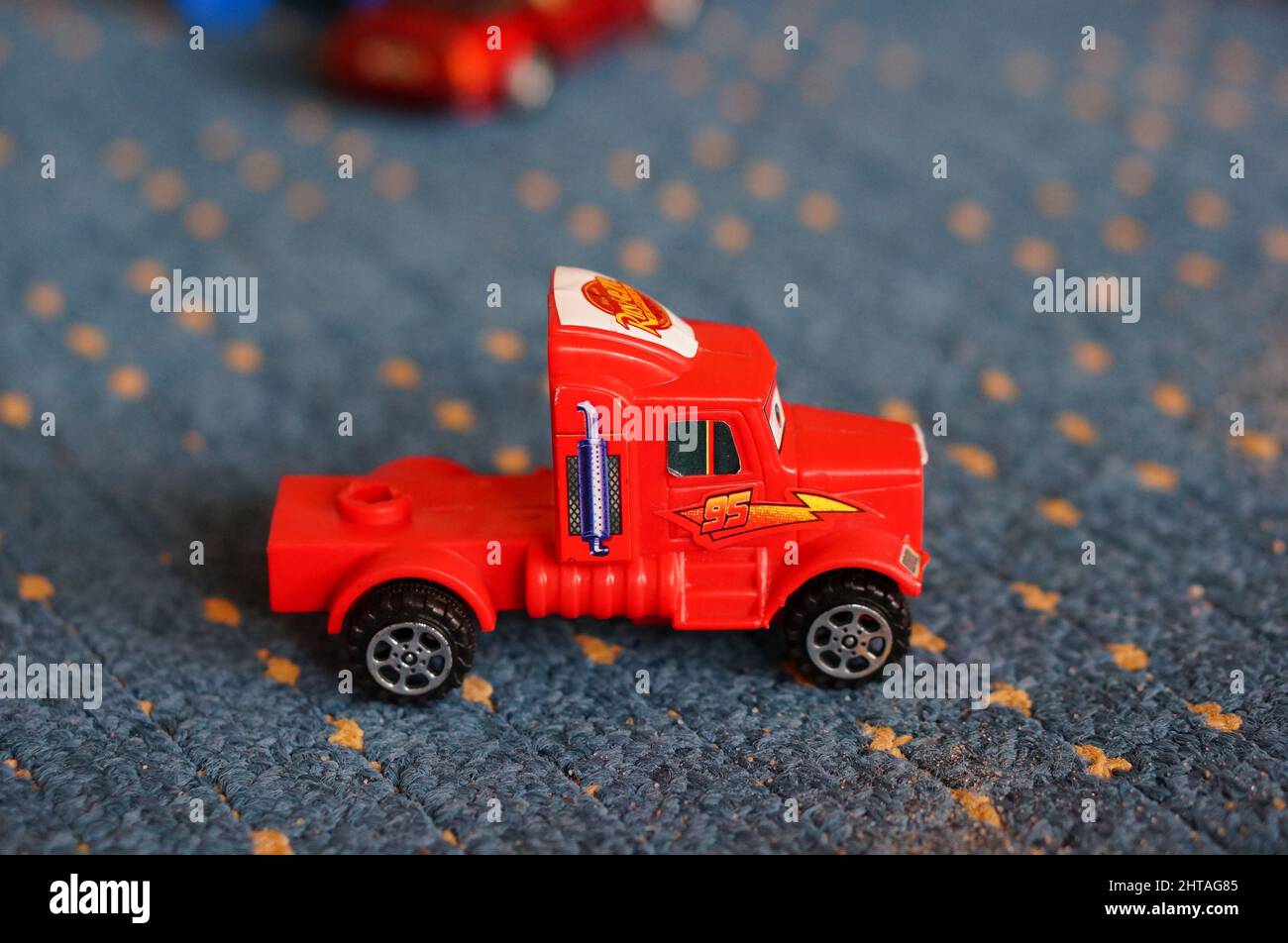 Closeup shot of the red toy truck model of the Disney Pixar Cars on the ...
