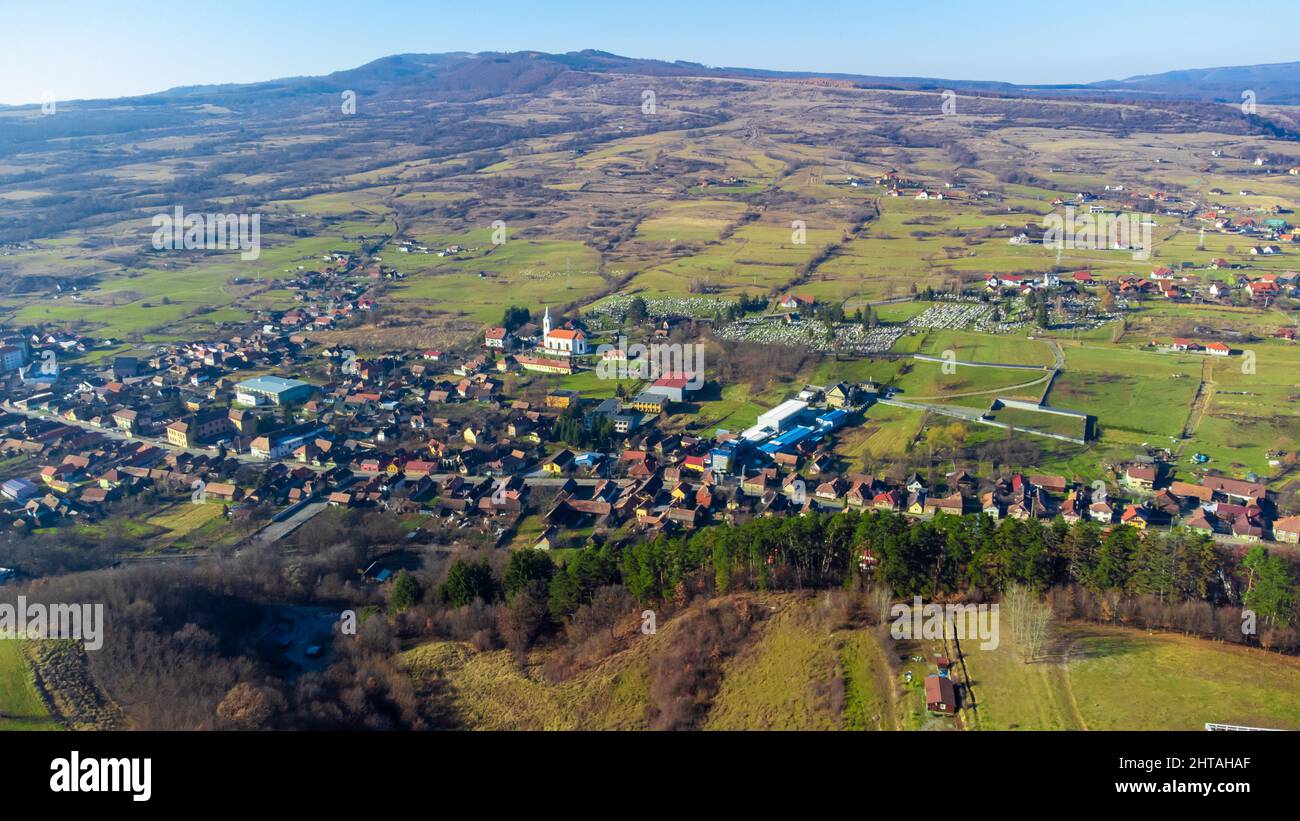 Aerial view of a town surrounded by green mountains in Romania Stock ...