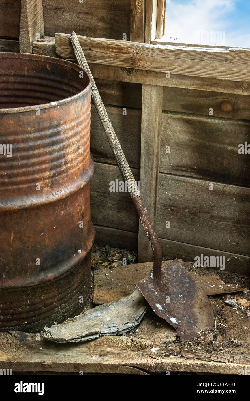 old shovel and rusted barrel in a deserted home Stock Photo - Alamy