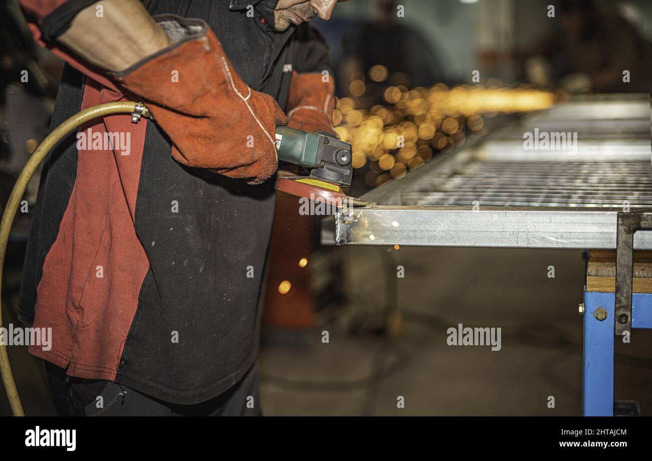 Close-up of an unrecognizable Caucasian man using a grinder with ...
