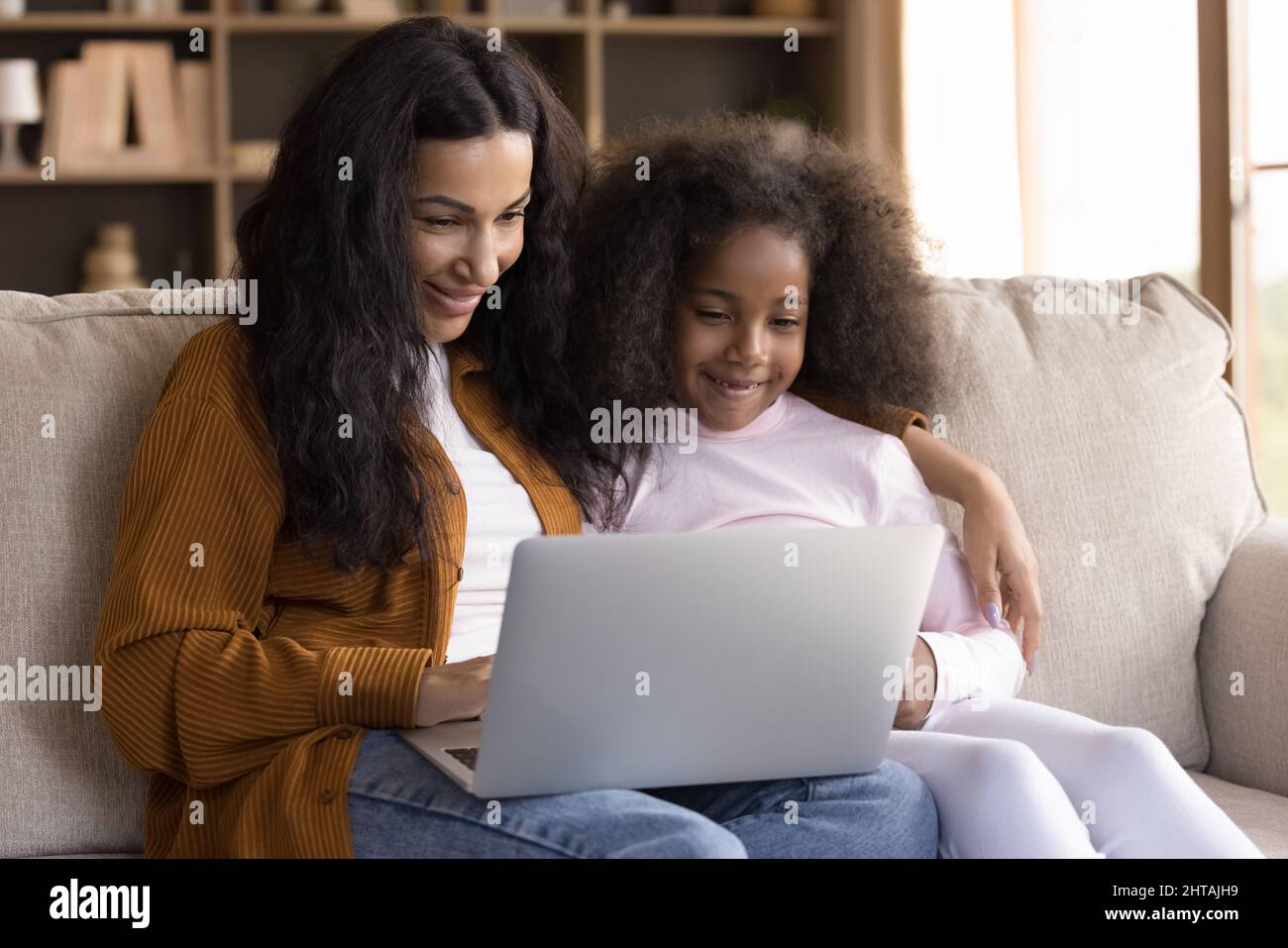 Happy beautiful African American family using computer Stock Photo - Alamy