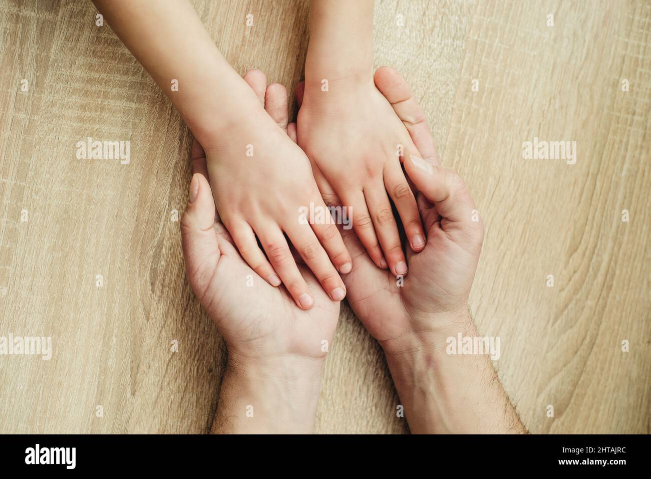 children's hands and adult hands on the background Stock Photo - Alamy