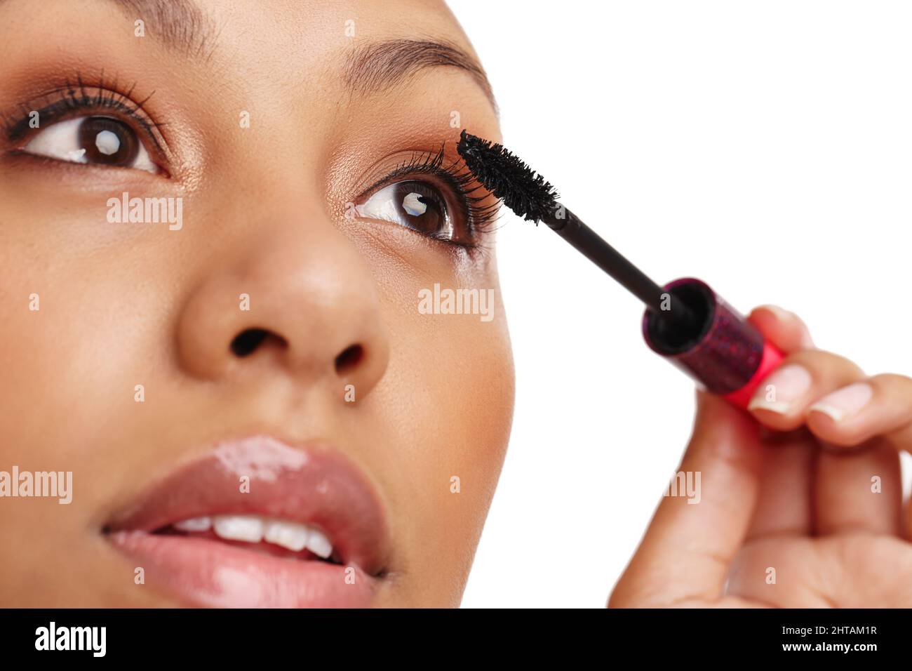 Artist at work. Cropped shot of a gorgeous young woman applying mascara ...