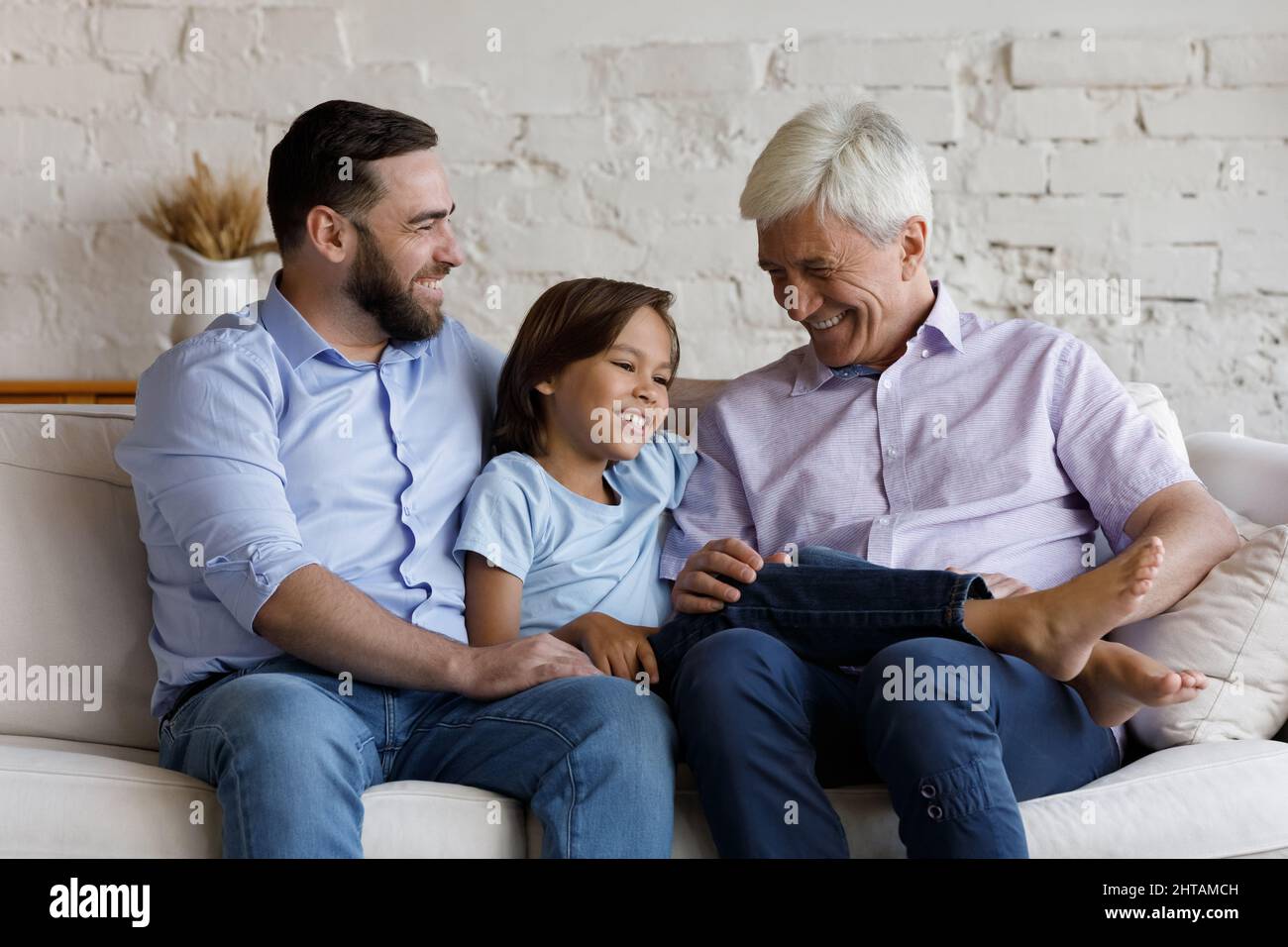 Three generations men family spend time together at home Stock Photo ...