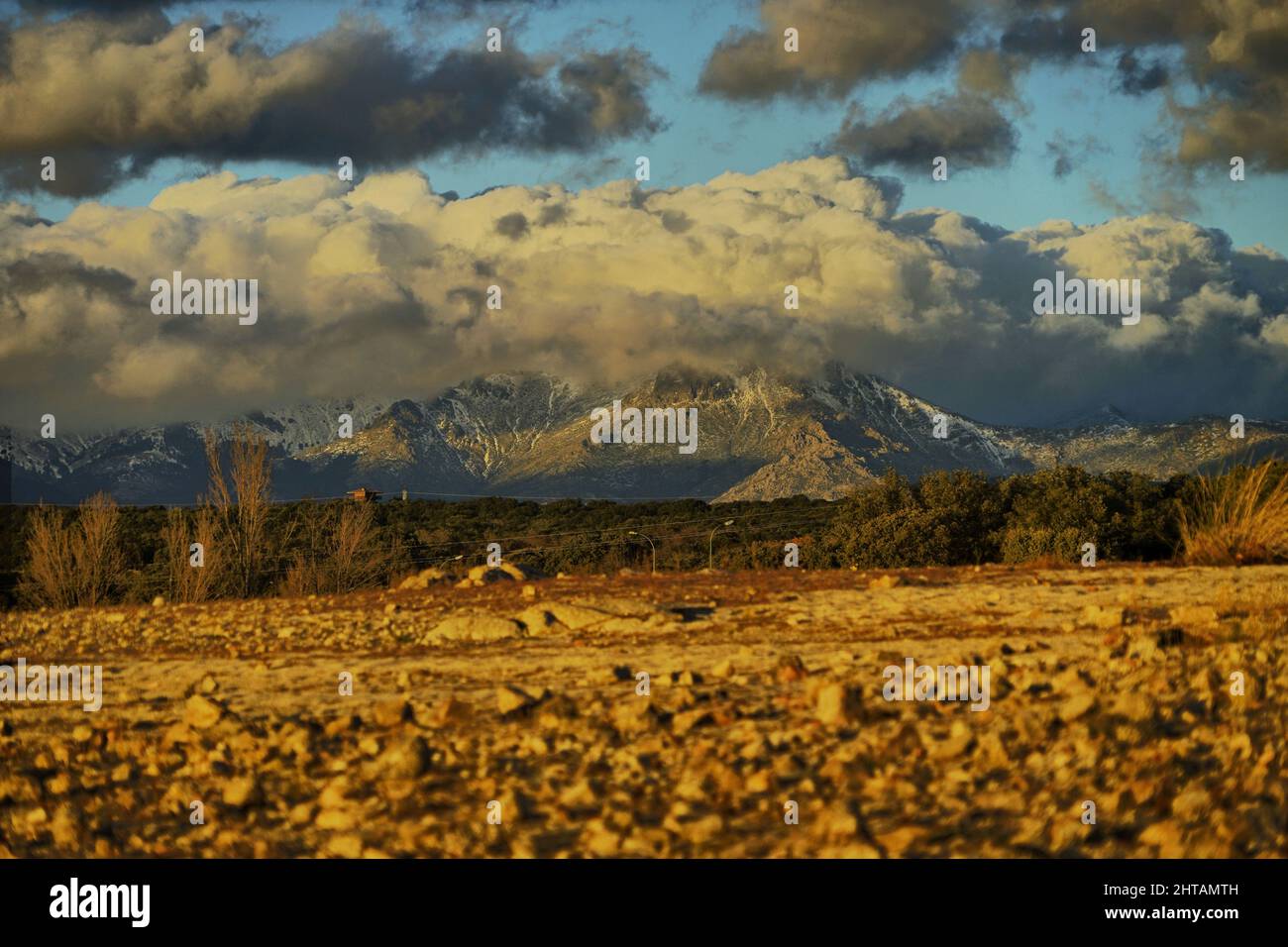 Landscape of a snowy mountains with clouds above it Stock Photo - Alamy