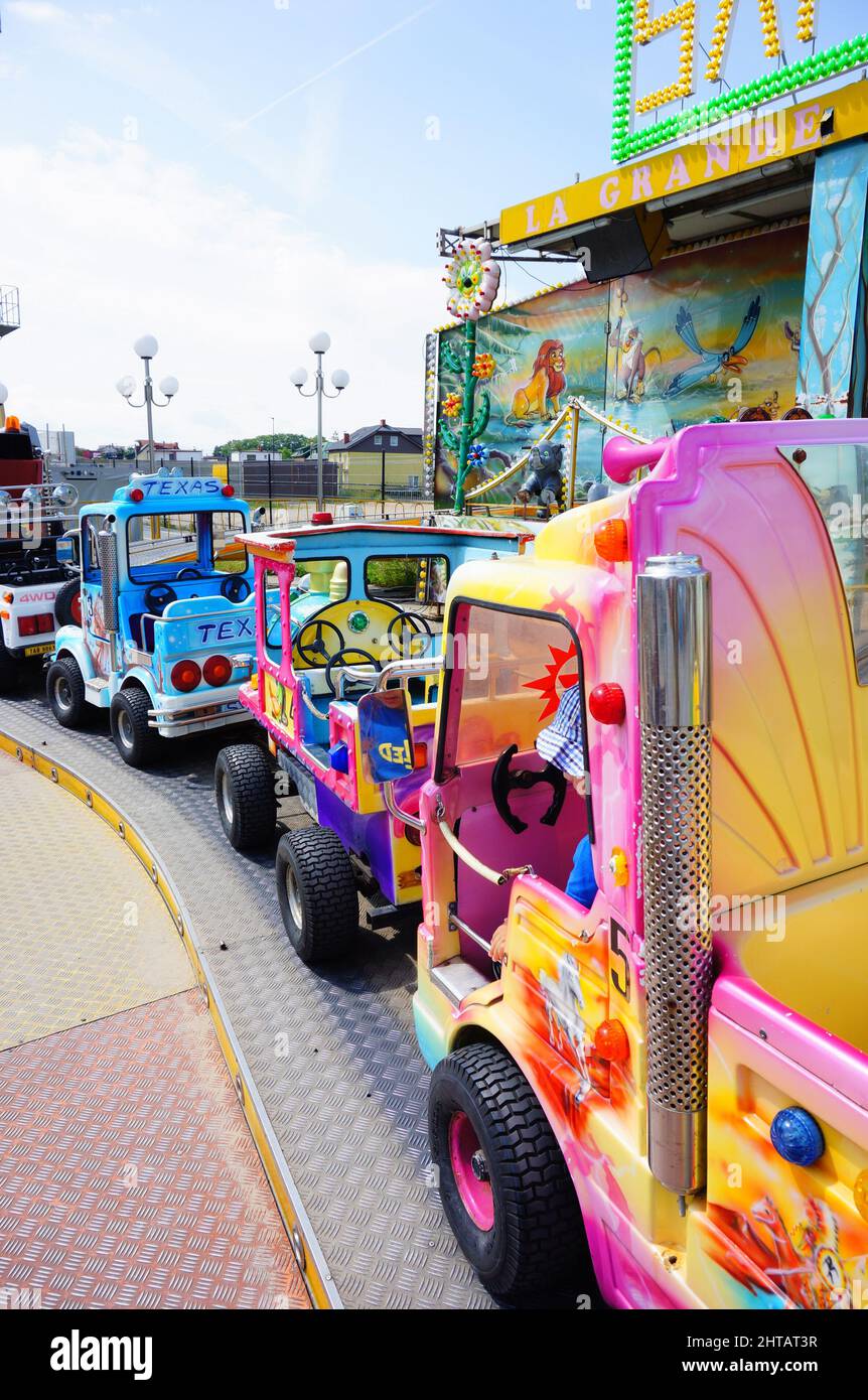 Colorful carousel attraction at a fair by the seaside Stock Photo - Alamy
