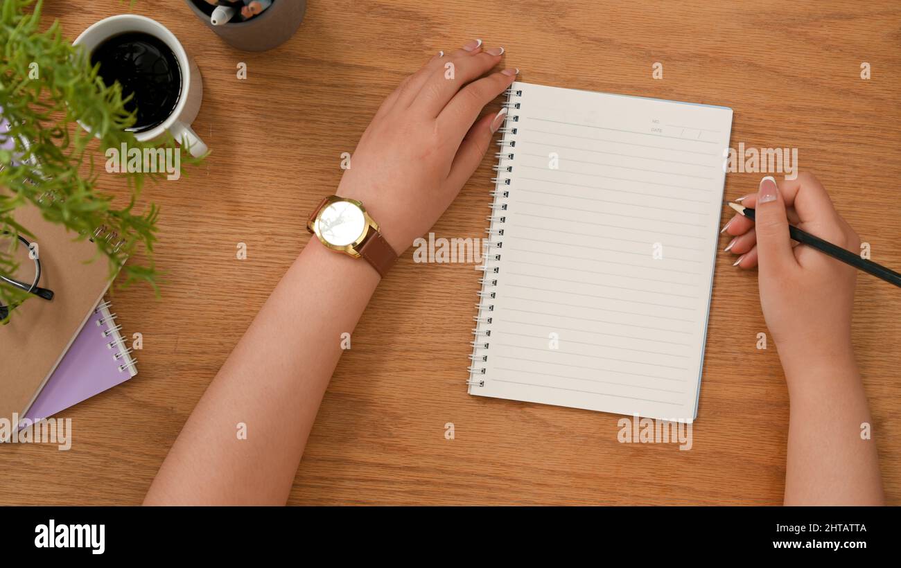 Top view, Female college student lecturing something on notepad, doing ...