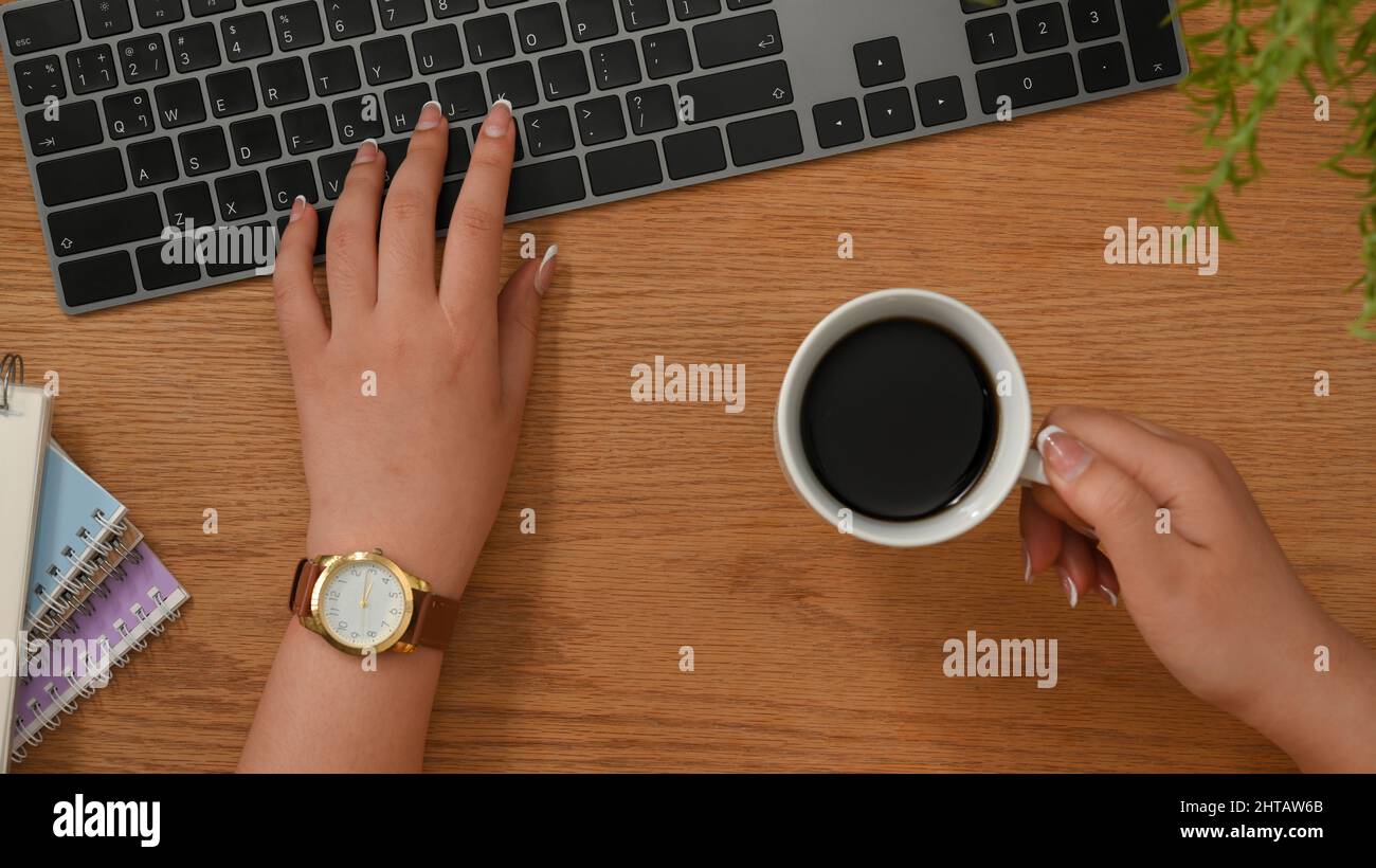 Close-up, top view, A female officer working on computer, typing on ...