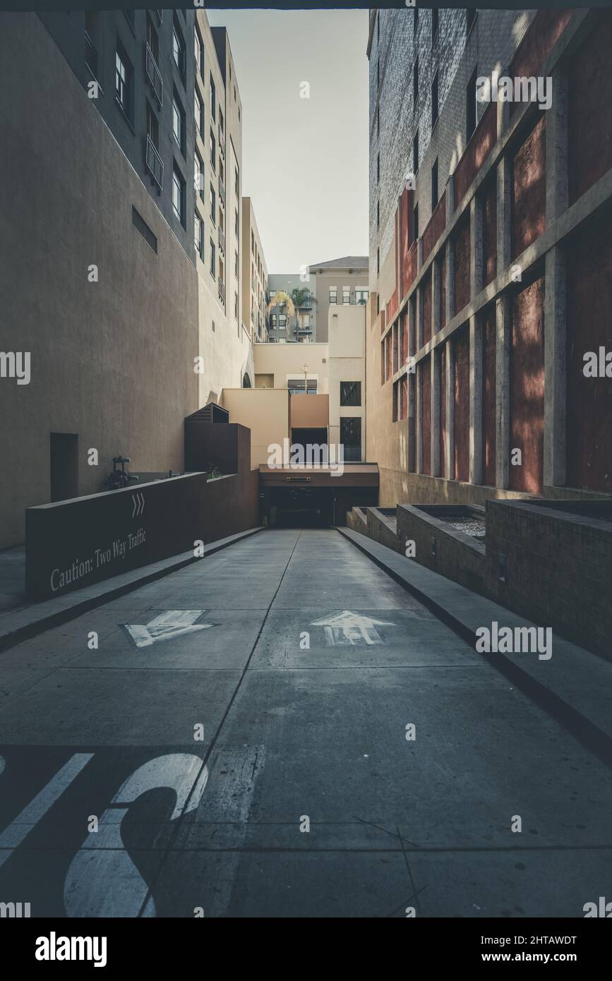 Alleyway leading towards a parking garage Stock Photo - Alamy