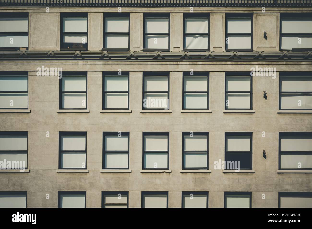 Tall building with repetitive windows Stock Photo - Alamy
