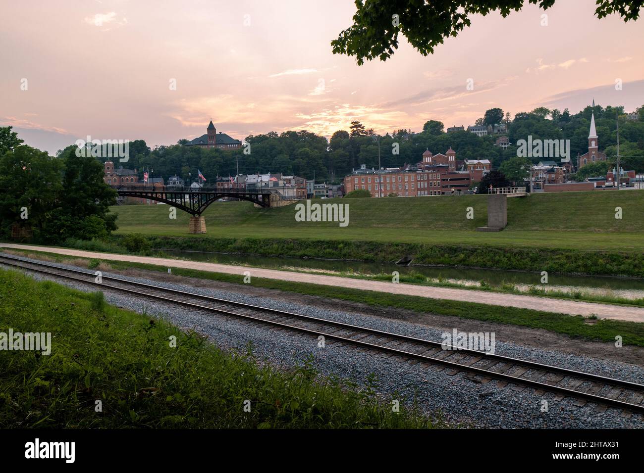 Railroad along by the river and grant park pedestrian bridge at sunset ...