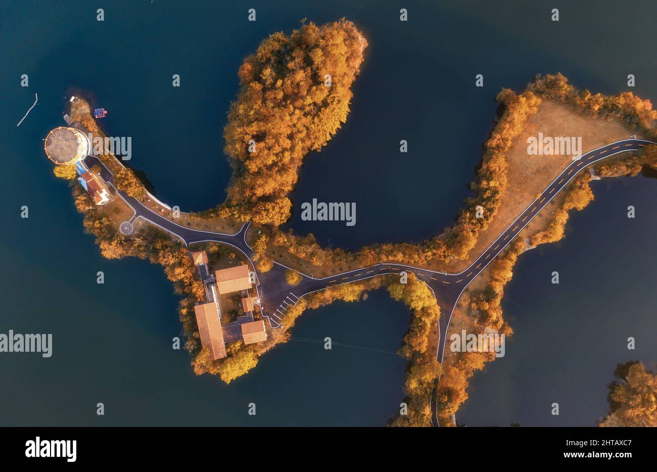 Top view of an asphalt road on a small island surrounded by the vast ...