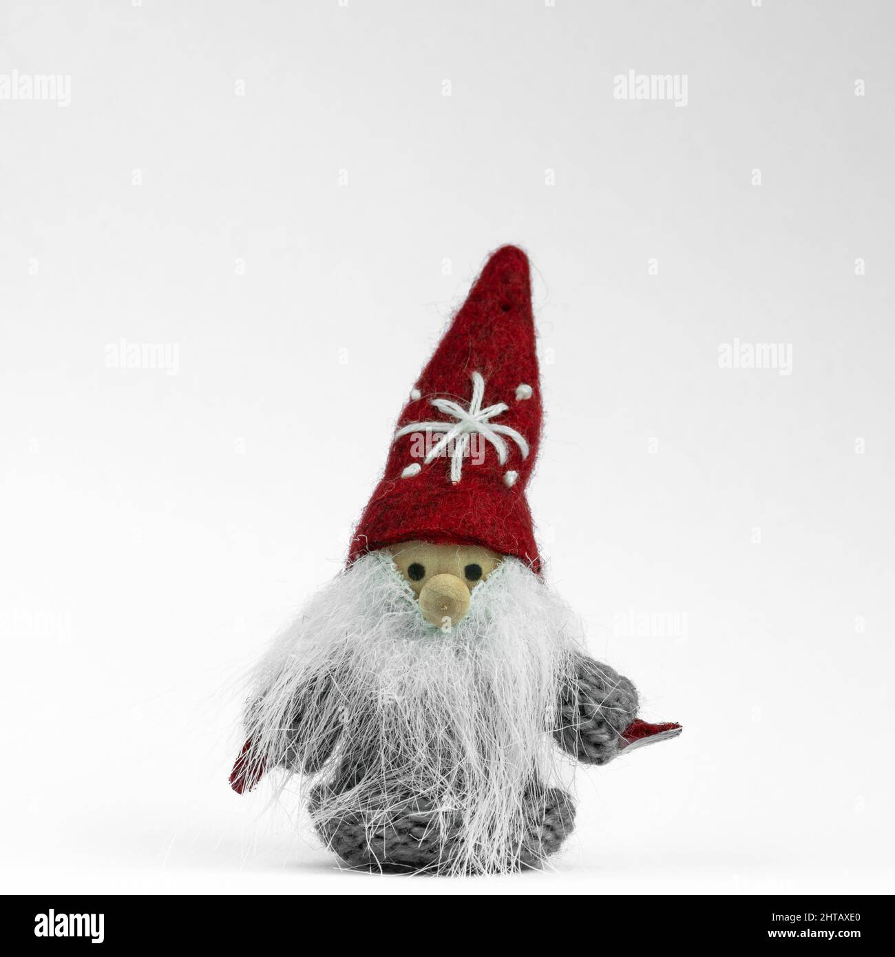 Christmas dwarf toy with white beard and tall hat on white background ...