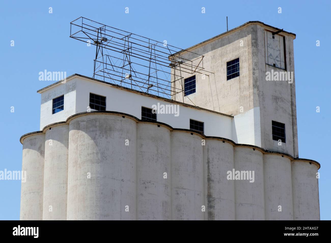 Closeup of the grain silo with white facade and metal construction on ...