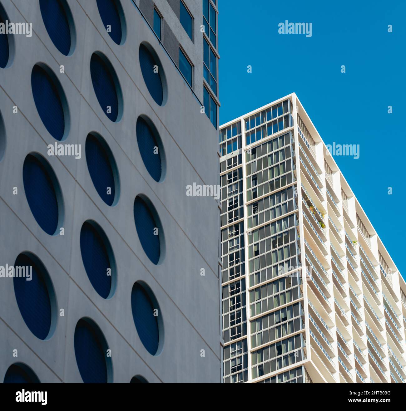 Modern urban buildings with round and rectangular windows under the ...