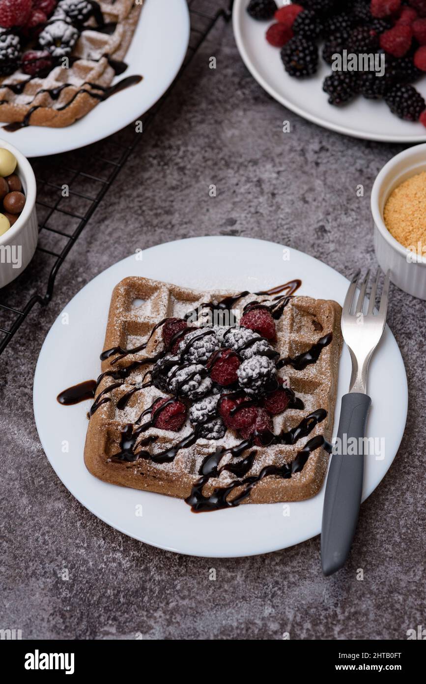 Photo of chocolate waffle with raspberries, a bowl of chocolate, and ...