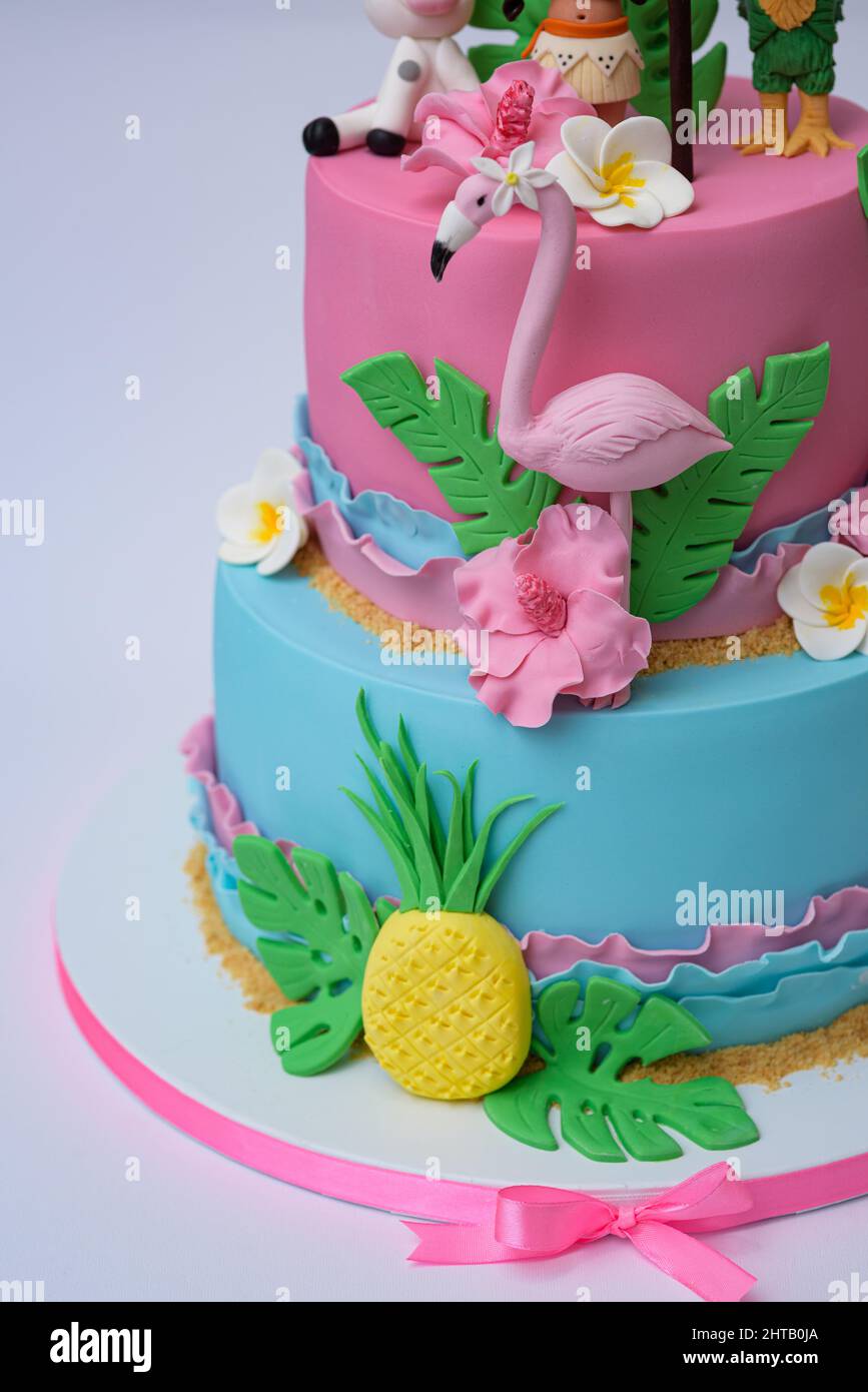 Vertical photo of Moana and flamingo theme layer cake Stock Photo - Alamy