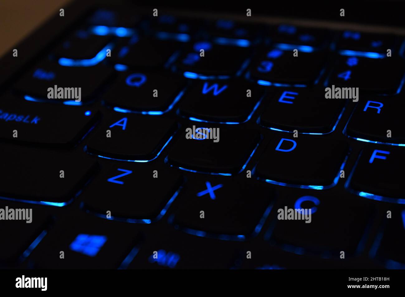 Macro shot of a black keyboard with LED-lit blue lights Stock Photo - Alamy