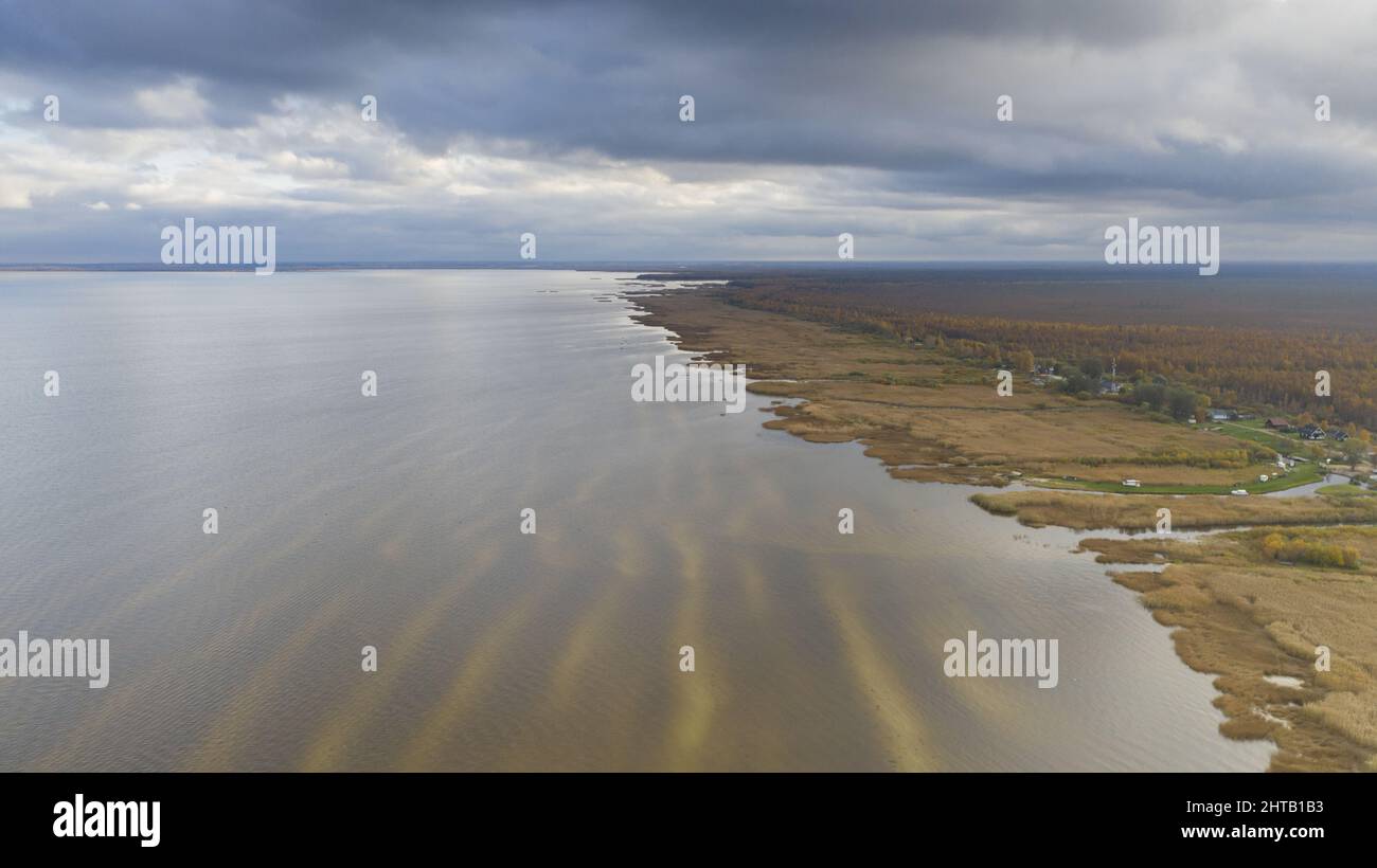 Aerial view of sandbars and dramatic gray sky reflecting on Peipsi lake ...