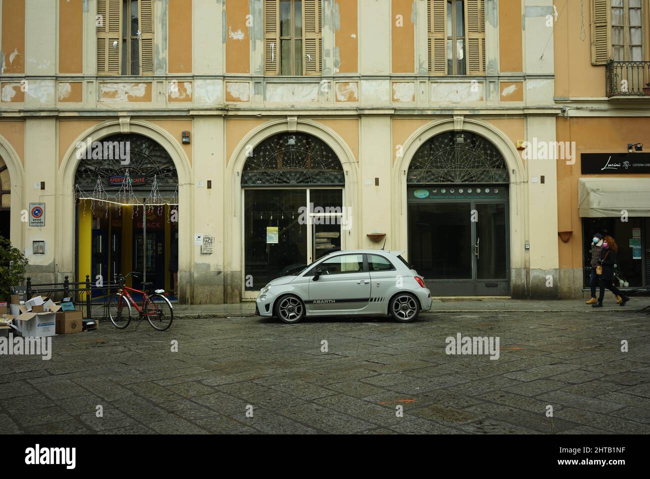 Street view of an old building and Fiat 500 Abarth parked in front ...